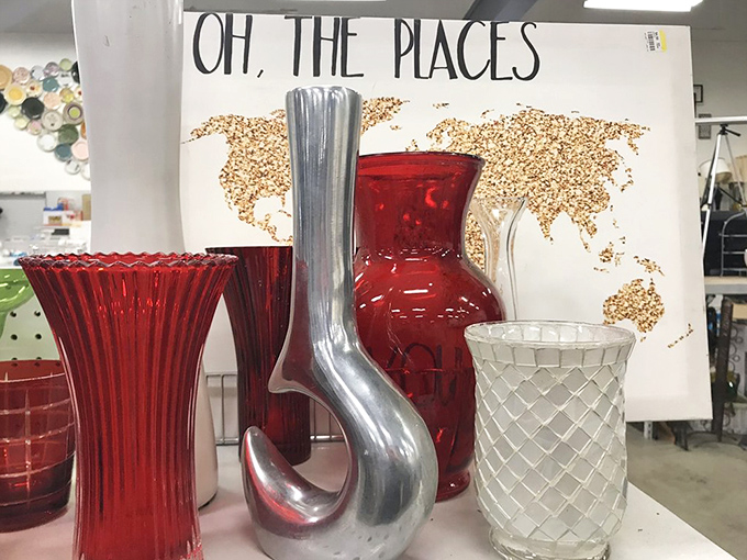 Dr. Seuss would approve of this eclectic vase collection, where sleek silver sculptures mingle with ruby red glassware against a world map backdrop.act.