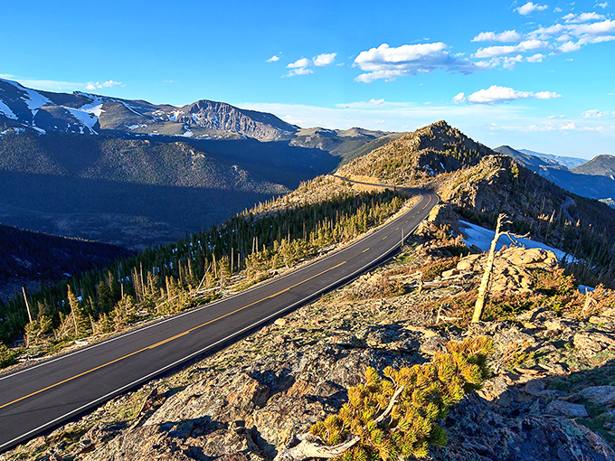 The road clings dramatically to mountainsides like nature's roller coaster, designed by geological forces with a flair for drama.