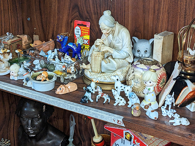 The island of misfit figurines. This collection of porcelain personalities seems to be having their own tiny reunion while waiting for new homes.