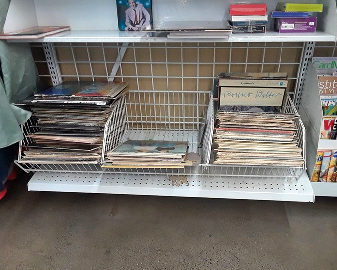 Vinyl records lean against each other like old friends at a reunion, each album cover a time capsule waiting to be rediscovered.