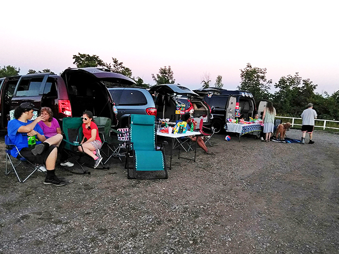 Tailgating meets cinema as families transform their vehicles into cozy living rooms with wheels. Community at its finest.