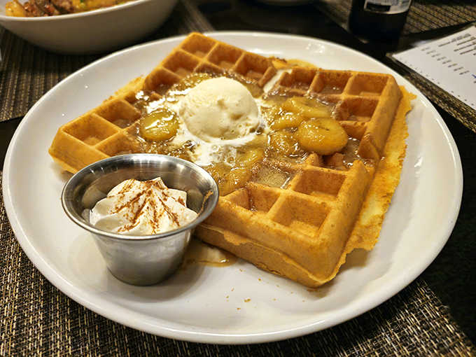 A waffle that's clearly overachieving&mdash;golden, crisp, topped with caramelized bananas and ice cream melting into those perfect squares.
