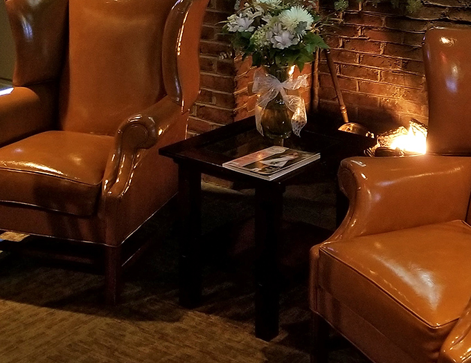 Leather wingback chairs create a cozy nook that whispers, "Stay awhile." The kind of spot where great conversations and nightcaps naturally occur.