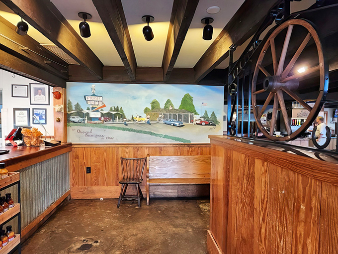 That mural and wagon wheel aren't just decoration; they're a visual love letter to barbecue tradition in a space that feels like coming home.
