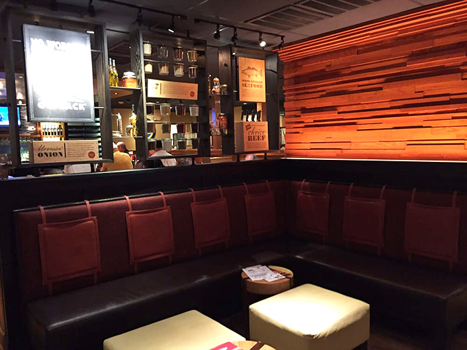 Rich wood paneling and coral seating create the perfect waiting area, where anticipation of steak becomes its own appetizer.