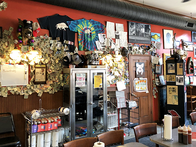 The wall of memorabilia, dollar bills, and barbecue accolades tells a story of community love and smoked meat devotion that money literally can't buy.