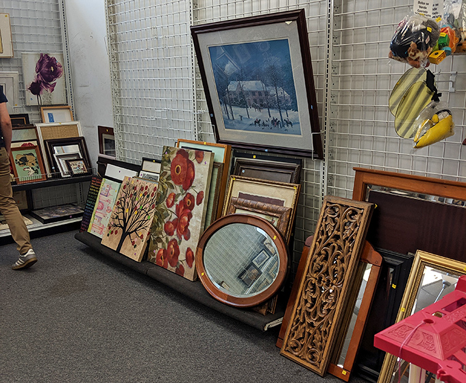 Wall art leans casually against the display&mdash;from winter landscapes to abstract florals, someone's former decor becomes your new conversation piece.