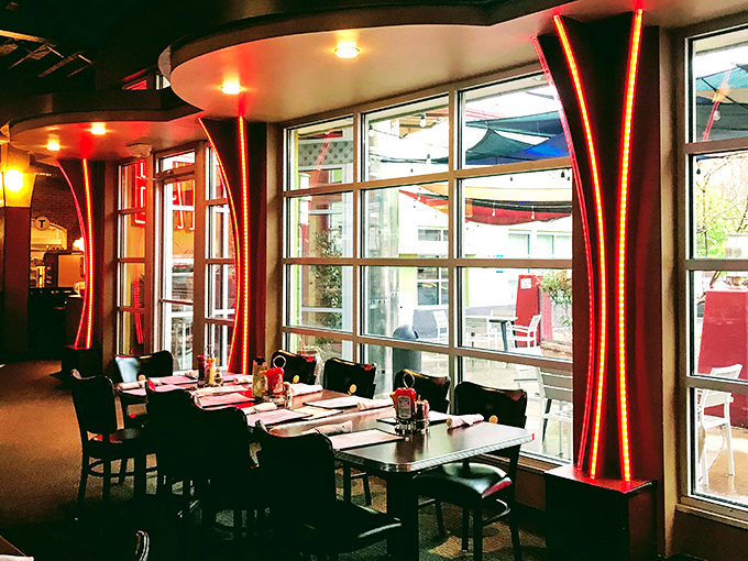 Dramatic red lighting transforms ordinary window seating into something from a Wes Anderson film. Breakfast with a side of cinematic ambiance.