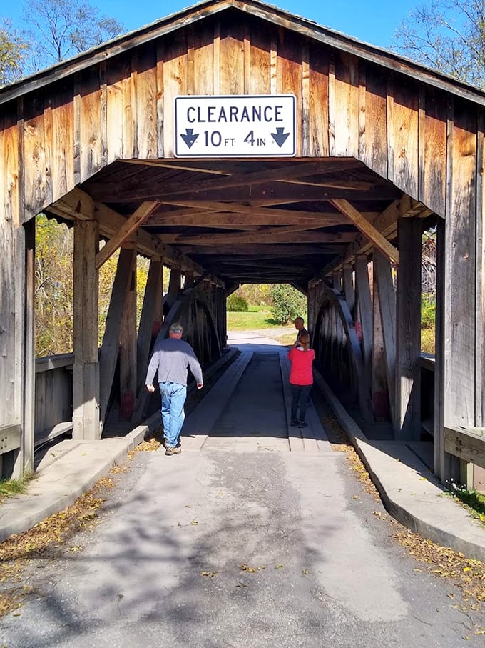 Visitors provide scale to this magnificent structure, where walking through feels like stepping into a sepia-toned photograph.