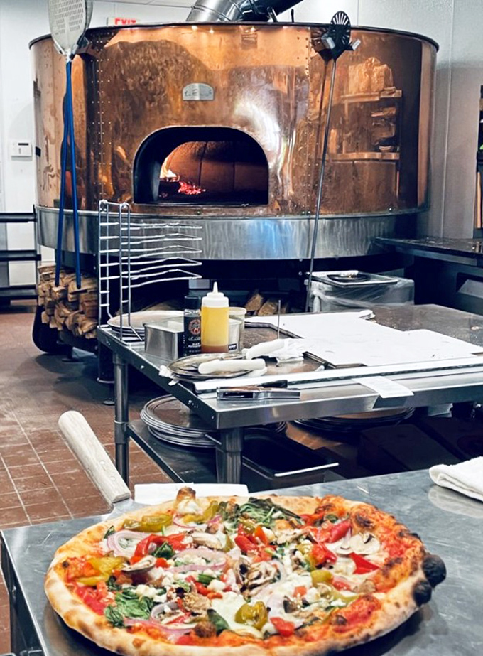 The magnificent copper oven isn't just equipment &ndash; it's the beating heart of Billy Bricks, radiating 800 degrees of pure culinary passion.