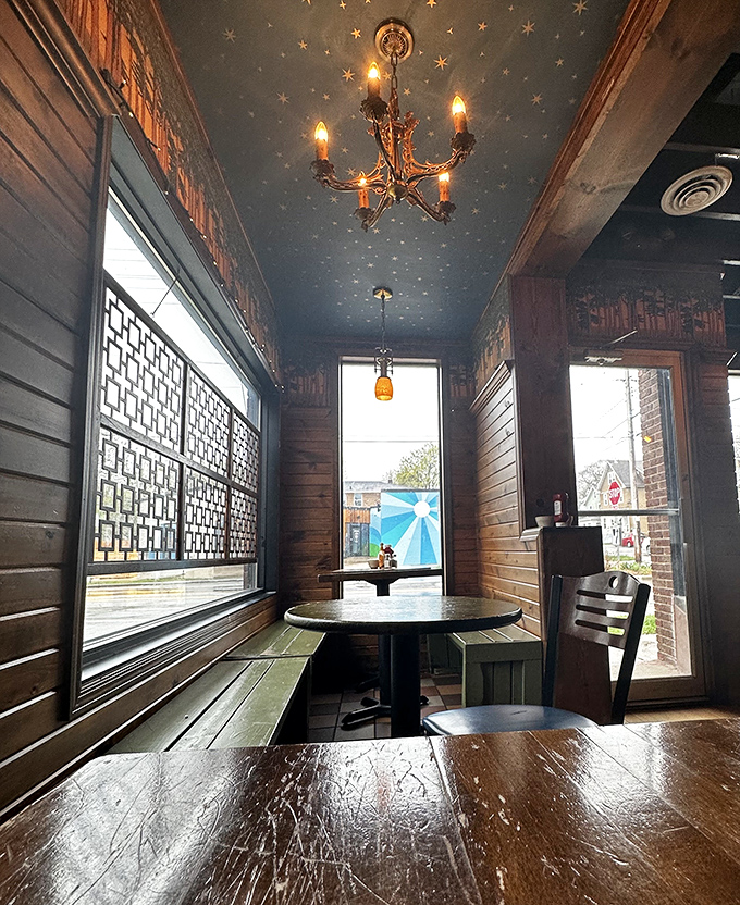 That starry ceiling and wooden booth create a space that feels like you're dining in a cabin that happens to serve exceptional food.