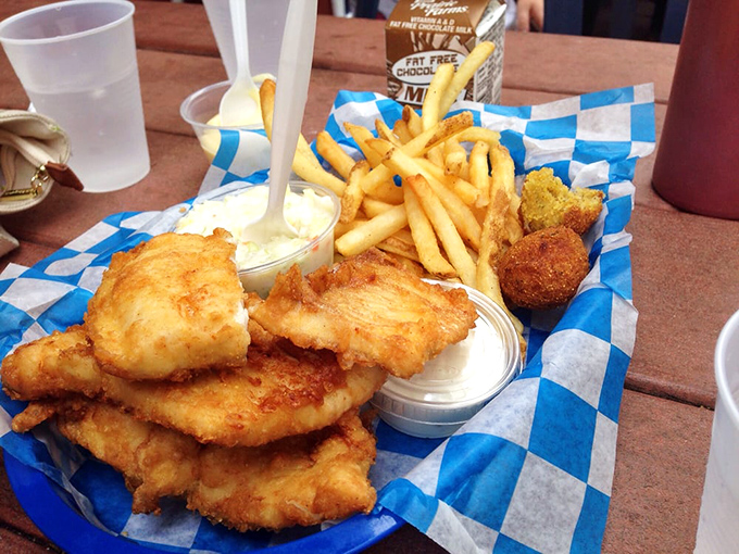 Layer upon layer of flaky whitefish fillets stacked like treasure, flanked by golden fries and creamy coleslaw&mdash;a Michigan feast fit for royalty.