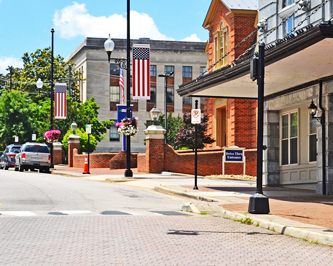 American flags flutter proudly along Main Street, where small-town patriotism meets architectural preservation in perfect harmony.