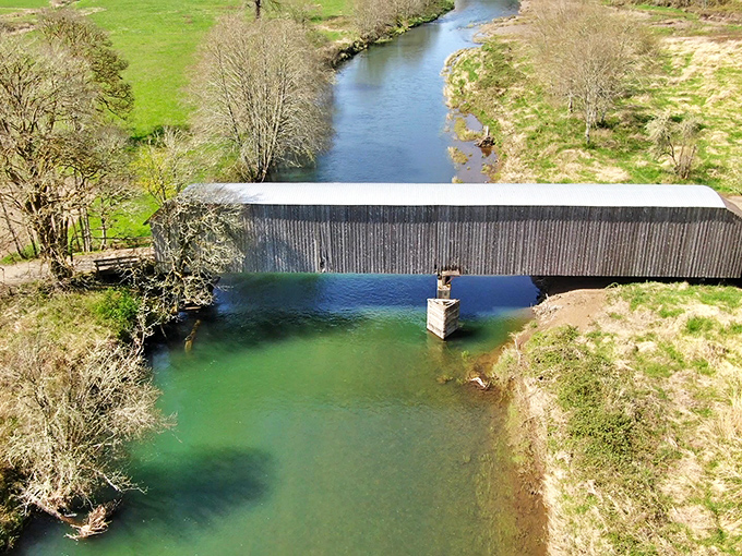 From above, you appreciate how perfectly the bridge connects the landscape. That emerald water below makes for a picture-perfect setting.