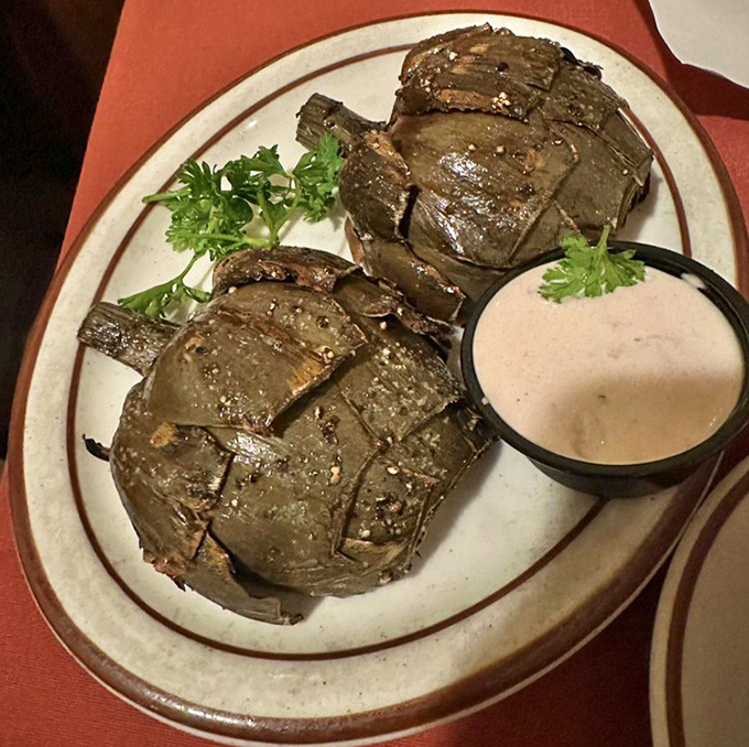 Artichokes transformed from armored vegetables into tender delicacies&mdash;proof that the Hitching Post's mastery extends beyond meat to everything that crosses their grill.