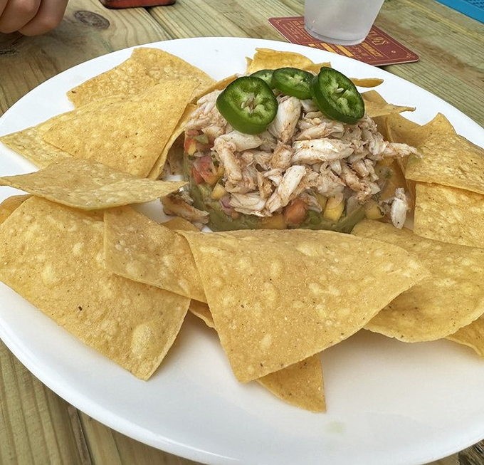Avocado crab tower &ndash; where California meets Chesapeake in a architectural marvel of seafood. Those tortilla chips aren't just garnish, they're essential structural support.