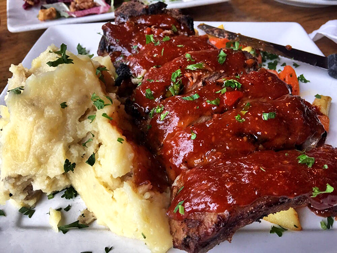 These ribs don't just fall off the bone &ndash; they practically leap onto your fork, glazed in a sauce that balances sweet, tangy, and smoky in perfect harmony.