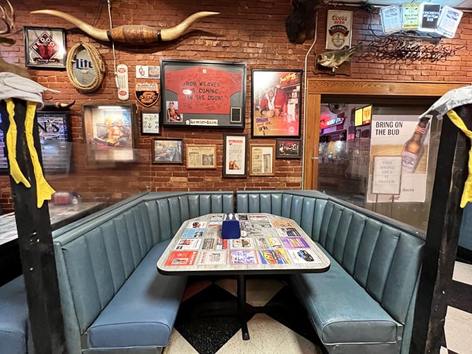 The blue banquette seating area where countless chicken stories have been shared. That longhorn overhead has witnessed decades of satisfied diners.