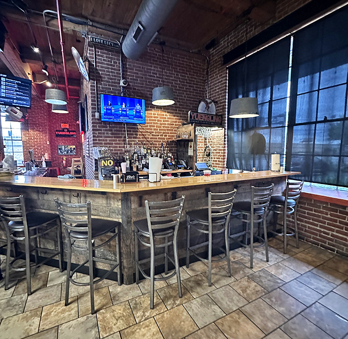 The bar area offers a front-row seat to the action, where barbecue discussions flow as freely as the beverages.