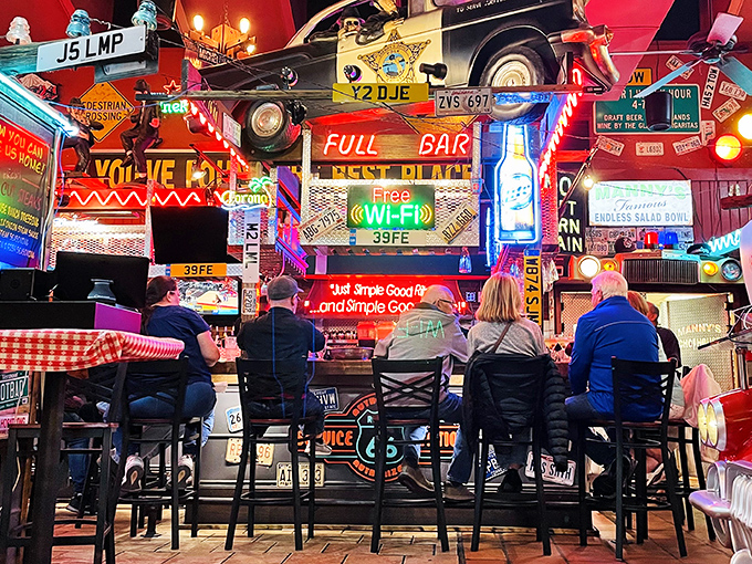 The bar area doesn't just serve drinks—it serves atmosphere, with enough neon to light up the night and conversation-starting decor everywhere you look.