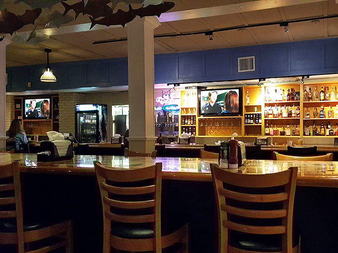 The bar area glows with amber warmth, offering liquid courage for those still intimidated by the prospect of cracking crab legs in public.