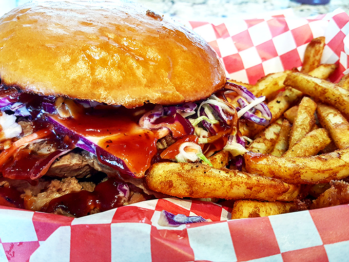 The brisket sandwich, where smoke-kissed beef meets pillowy bun and tangy slaw in a handheld miracle that requires both hands and napkins.