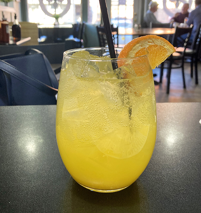 A sunshine-colored beverage that promises to brighten your day faster than any motivational poster ever could.