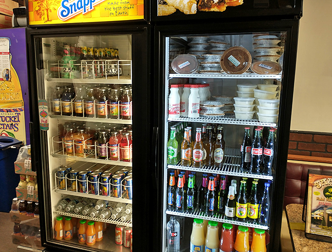 The beverage cooler&mdash;where exotic fruit drinks and classic sodas coexist peacefully, like the United Nations of refreshment options.