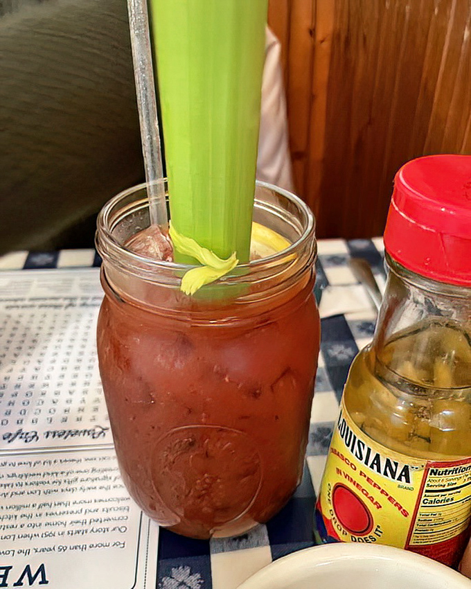 A Bloody Mary served country-style in a mason jar with a celery stalk tall enough to cast shade. The perfect companion to a leisurely Southern brunch.