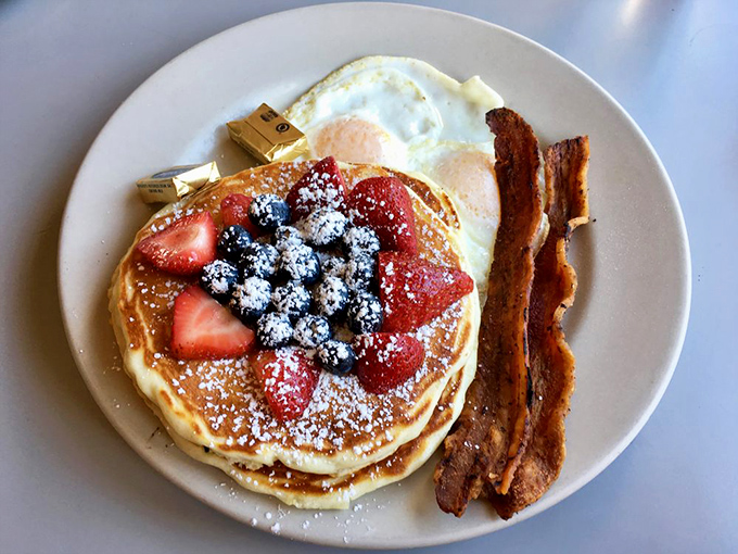 Pancakes that deserve their own Instagram account &ndash; fluffy discs of joy topped with berries, powdered sugar, and served with bacon that's achieved perfect crispness.