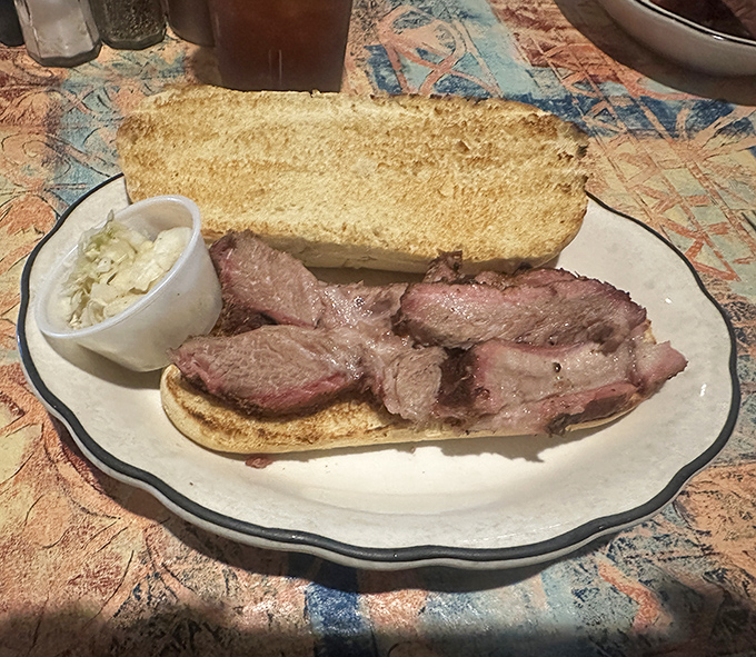The open-faced brisket sandwich isn't trying to hide anything &ndash; it's barbecue confidence on display with a side of slaw that knows its supporting role.