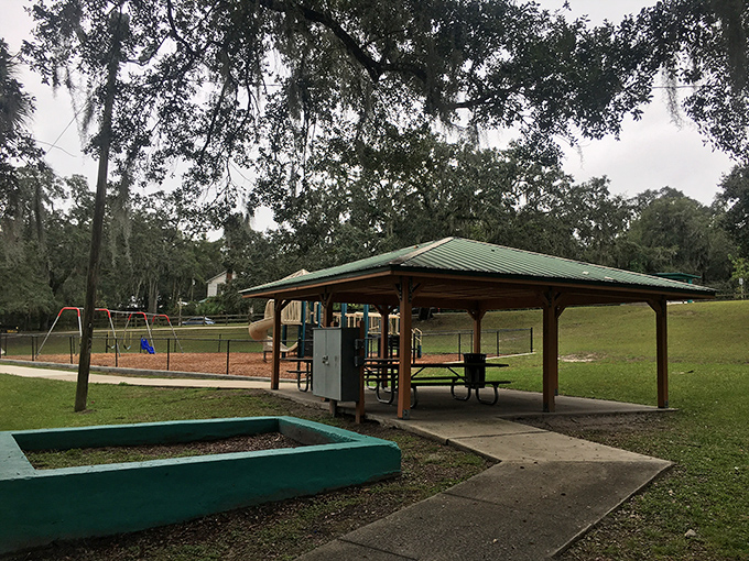 Bryan Park's pavilion stands ready for family gatherings, where three generations can argue about potato salad recipes under one metal roof.