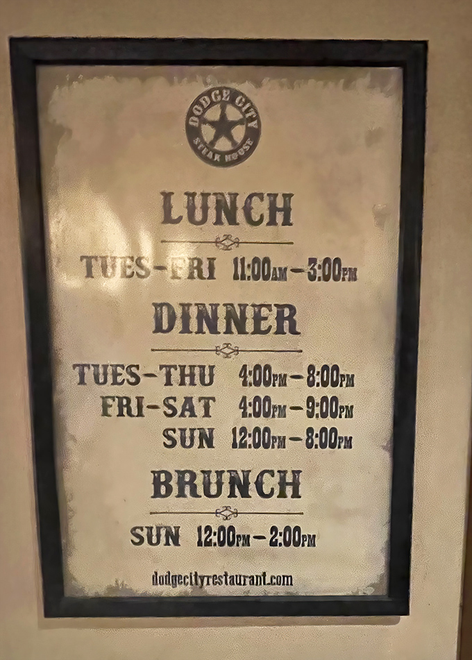 Business hours displayed with Old West typography&mdash;practical information delivered with thematic commitment that extends to every detail.