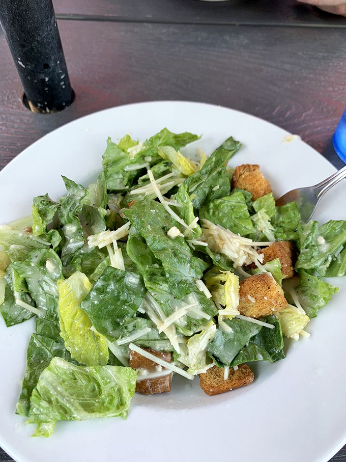 Even the Caesar salad gets the DK treatment. A reminder that sometimes you need something green to justify the three donuts you just inhaled.