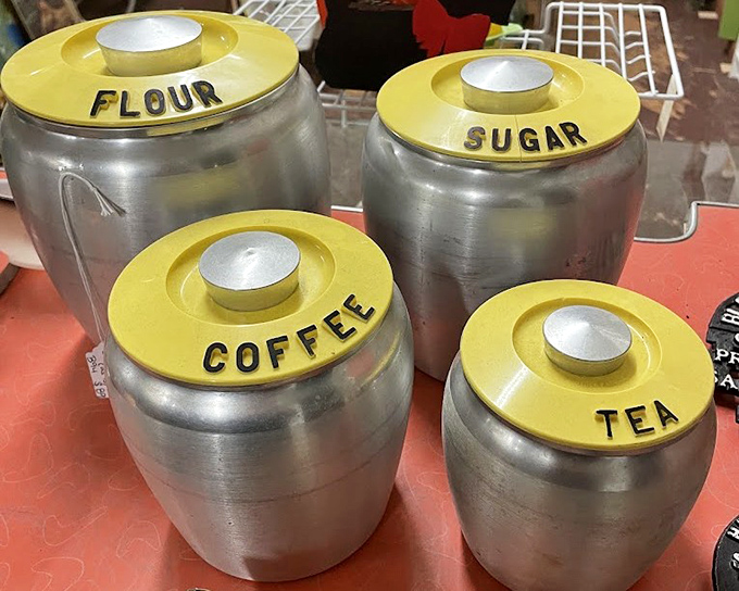 Mid-century kitchen canisters in aluminum and harvest gold&mdash;because nothing says "authentic vintage kitchen" quite like labeled sugar and flour containers.