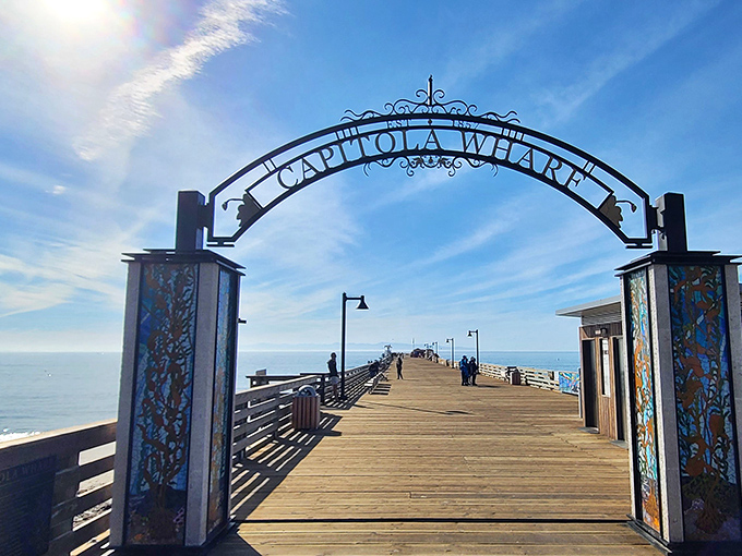 The iconic Capitola Wharf beckons visitors through its grand arch, promising fishing adventures and panoramic views worth every step.
