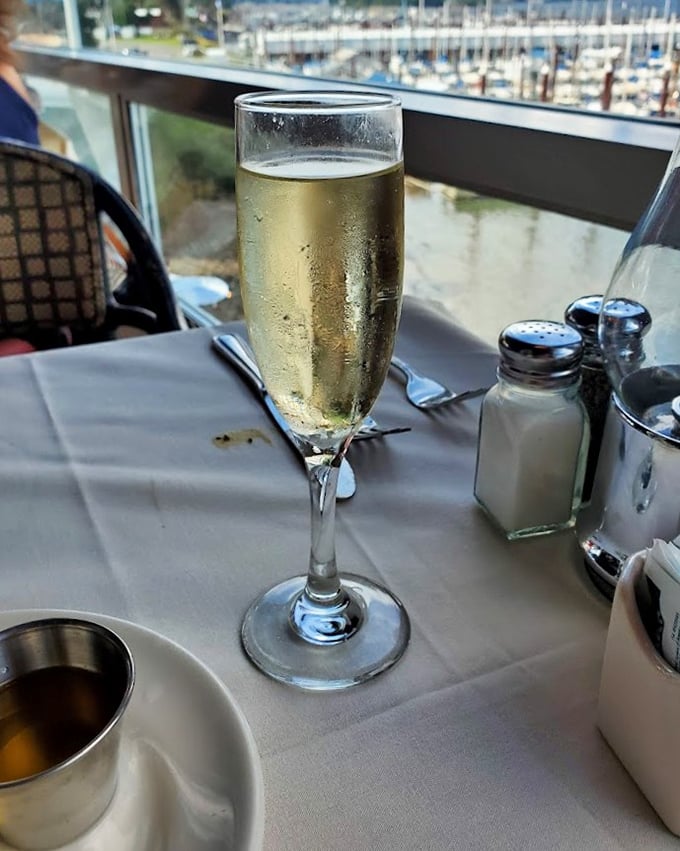 A glass of bubbly catching the river light&mdash;because sometimes you need to toast the view, the food, and the fact that you're not doing dishes tonight.
