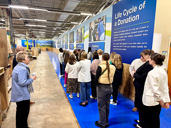 Behind the scenes&mdash;visitors learning about the lifecycle of donations and the community impact of their secondhand shopping.