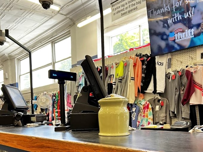 The checkout counter, where treasures become possessions. That yellow ceramic jar has probably witnessed thousands of thrifting victories.