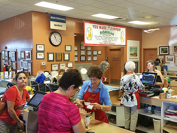The checkout counter buzzes with friendly volunteers helping customers complete their treasure hunting expeditions successfully.