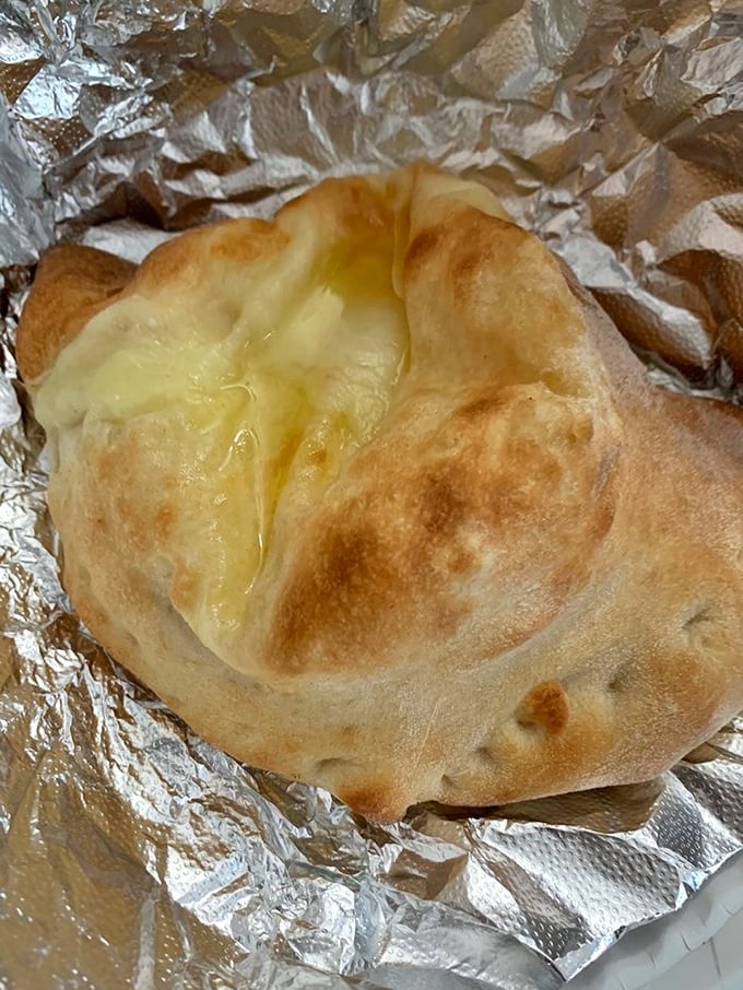 This calzone is what happens when cheese decides to throw itself a party and invites dough to be the venue.