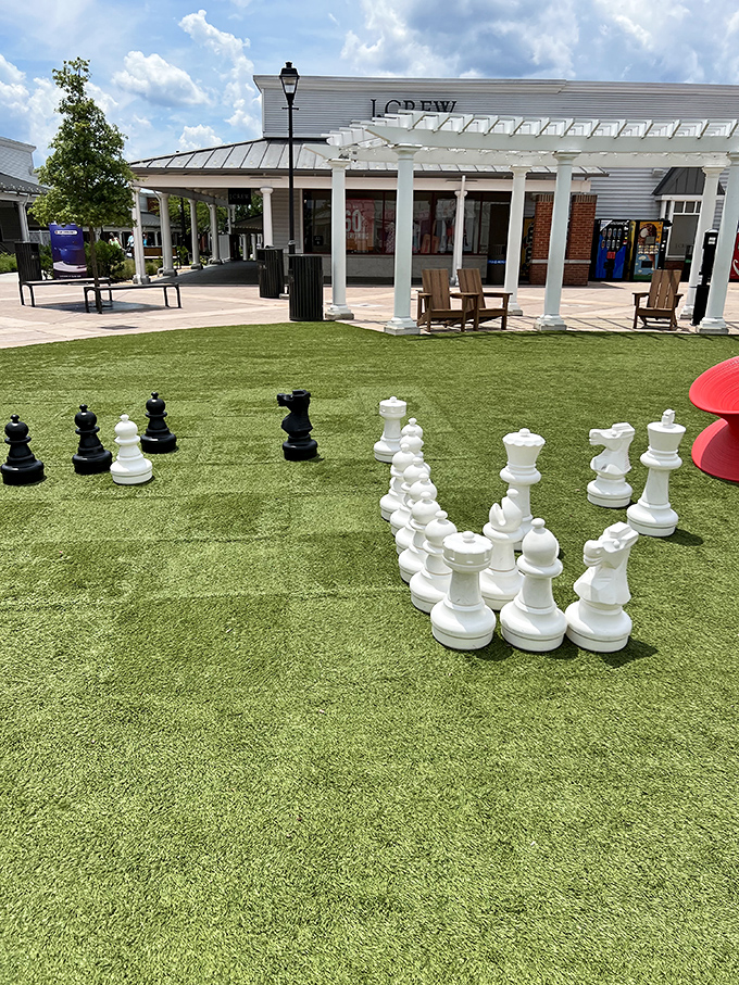 Giant chess pieces on artificial turf prove shopping centers have evolved beyond mere commerce into full entertainment destinations.