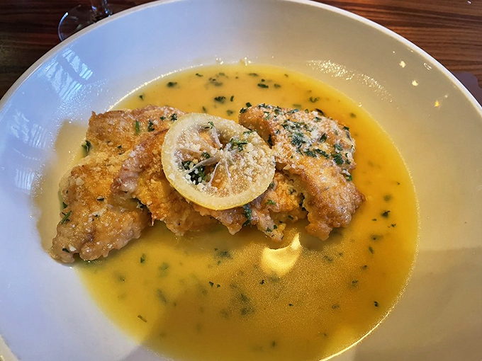 Chicken Francaise swimming in lemony butter sauce&mdash;proof that sometimes the simplest ingredients create the most profound flavors.