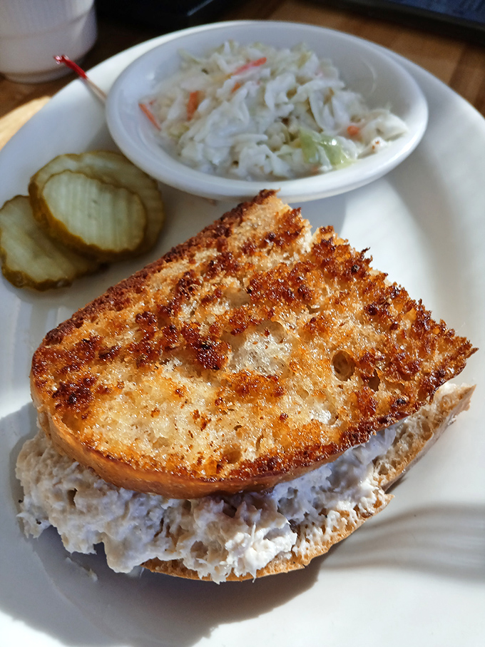 A chicken salad sandwich that your grandmother would approve of, served with coleslaw that provides the perfect tangy counterpoint to creamy comfort.