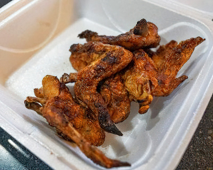 Smoked chicken wings with crispy, spice-rubbed skin&mdash;a testament that barbecue excellence extends beyond just ribs and brisket.