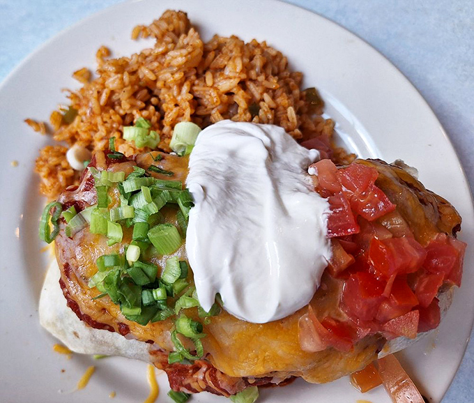 This burrito doesn't need a passport to prove its authenticity&mdash;topped with fresh scallions, sour cream, and enough cheese to make Wisconsin proud.