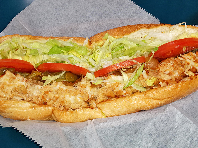Chicken gets the full hoagie treatment with fresh vegetables providing color contrast to the golden-brown protein beneath.