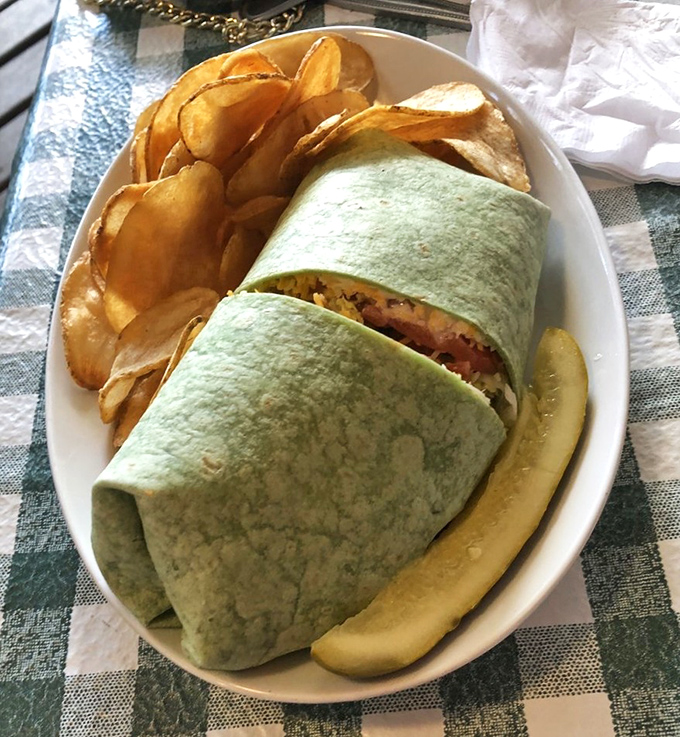 Lunch wrapped in possibility! This spinach tortilla embraces savory fillings alongside golden chips, creating a handheld masterpiece that's both familiar and adventurous.
