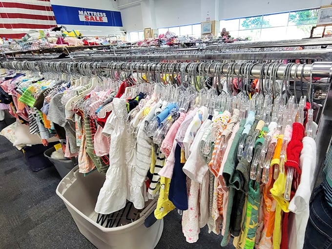 Tiny clothes in rainbow colors, ready to outfit the next generation of thrift store enthusiasts.
