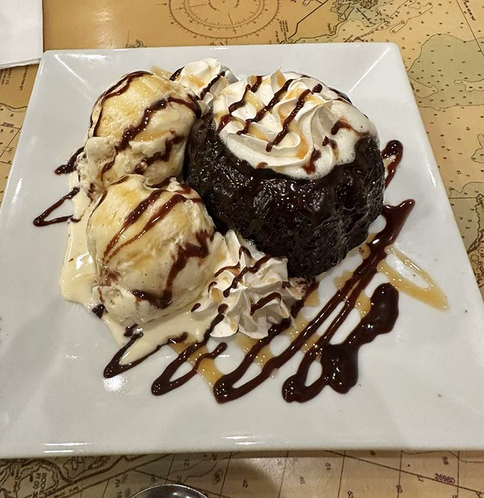A chocolate volcano cake that erupts with warm, gooey goodness. The ice cream is melting faster than my willpower ever could. 